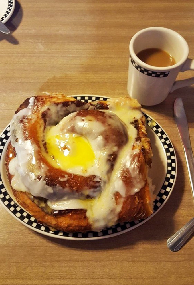 The cinnamon roll's crowning glory sits beside coffee in a checkered mug&mdash;the breakfast equivalent of winning the Indy 500.