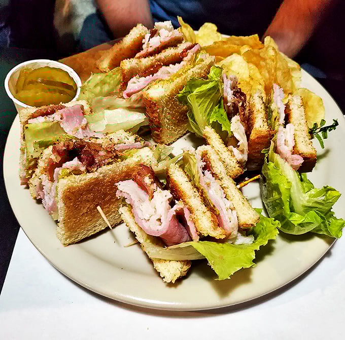 Club sandwiches stacked higher than my unread emails. The architectural integrity alone deserves a standing ovation.