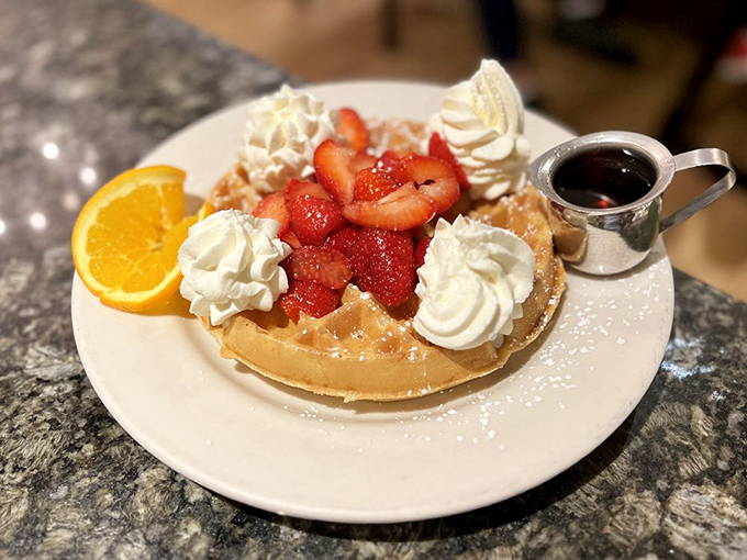 This Belgian waffle topped with fresh strawberries isn't just breakfast—it's the morning equivalent of winning the lottery.