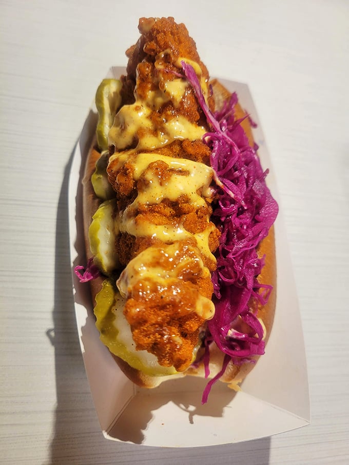 This isn't just a sandwich; it's a color story. Fiery chicken, sunshine-yellow sauce, and that electric purple slaw create edible art that tastes even better than it looks.