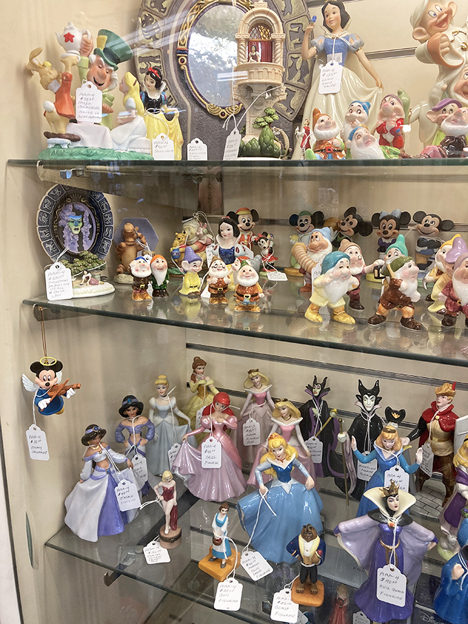 Disney figurines standing at attention like colorful sentinels of childhood. Snow White probably costs more now than your first car payment.
