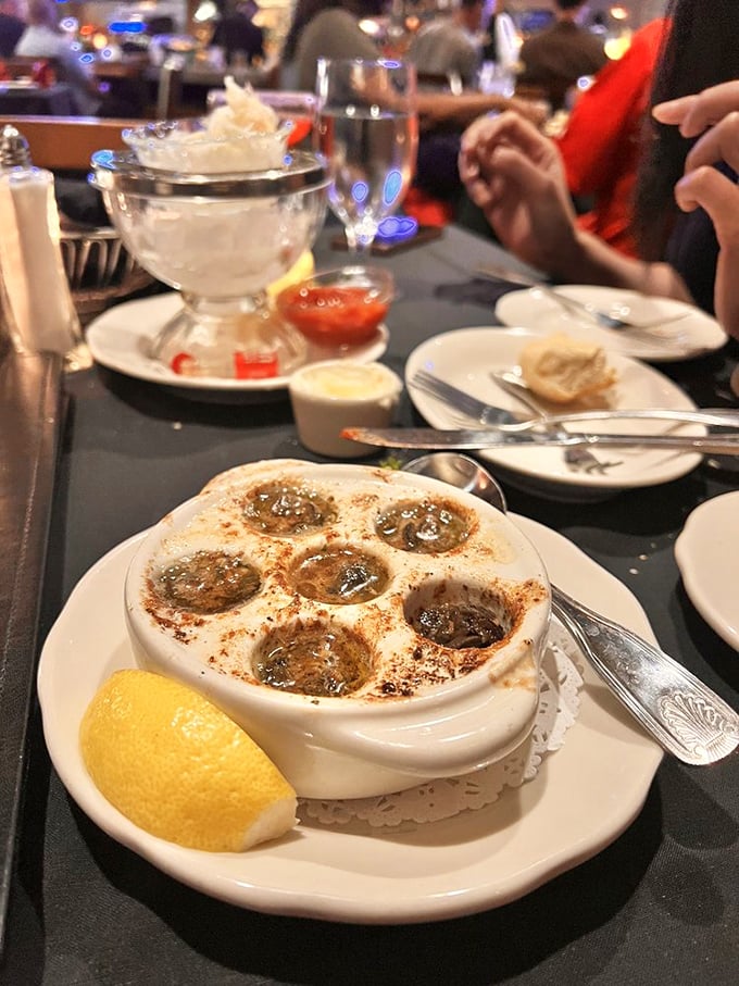 Escargot served in their little hot tubs of garlic butter—like tiny spa treatments for your taste buds that are worth every bit of French pronunciation anxiety.