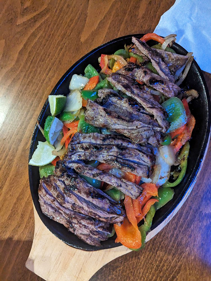 A sizzling skillet of fajitas that announces its arrival like a Broadway star—the peppers and onions providing the chorus to perfectly grilled meat.