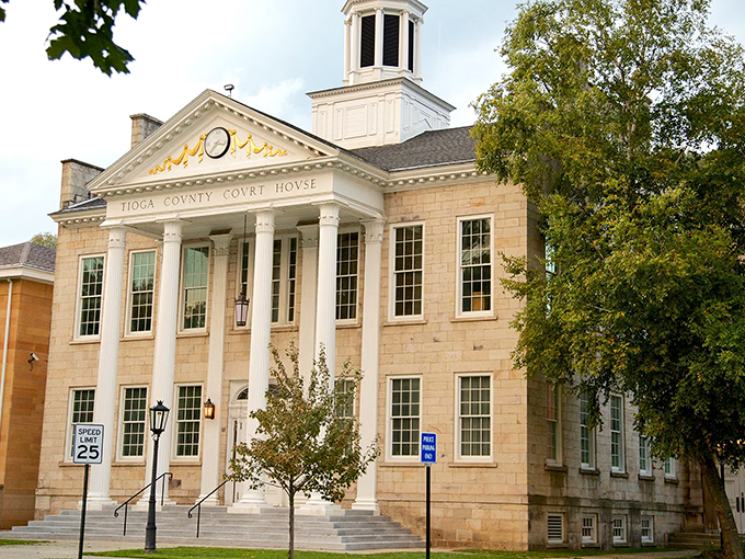 The Tioga County Courthouse stands as a testament to classical architecture, its white columns and dome creating a stately presence on Wellsboro's Main Street.