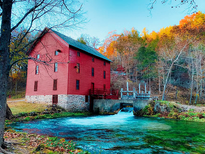 Autumn paints Alley Spring Mill in seasonal splendor, where the crimson mill and turquoise waters create a contrast that seems almost too perfect to be natural.