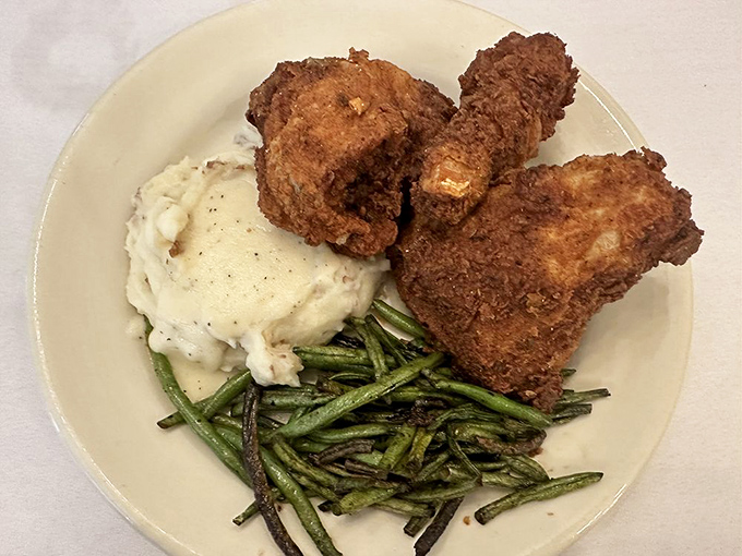 The Tavern's legendary fried chicken boasts a crackling golden crust guarding juicy meat within&mdash;a timeless recipe worth traveling for.