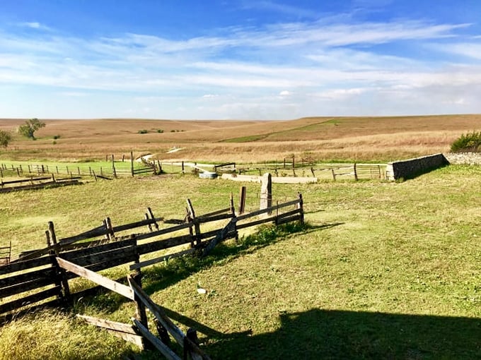 Rustic split-rail fences frame the rolling Flint Hills landscape, creating a scene straight from a Wyeth painting.