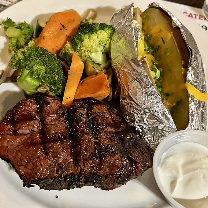 A perfectly executed steak with fresh vegetables&mdash;proof that sometimes the simplest pleasures are the most profound. That baked potato is living its best life.