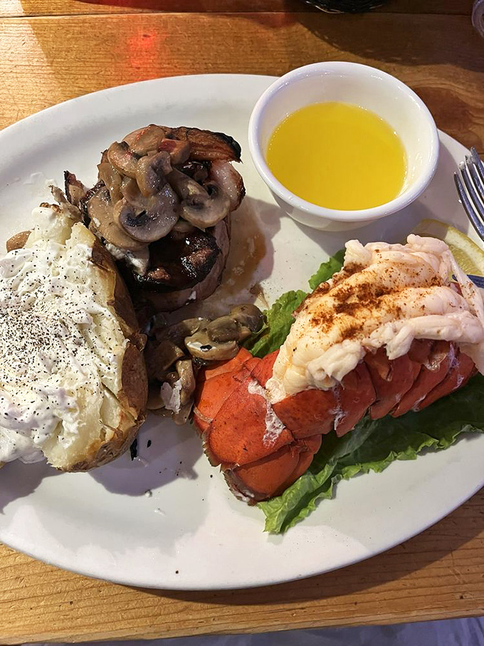 Filet mignon crowned with mushrooms alongside lobster tail &ndash; proof that sometimes the best relationships are the ones you eat.