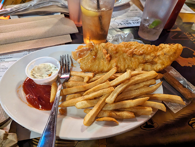 Fish so perfectly fried it deserves its own golden trophy, with french fries standing at attention like they know they're in good company.