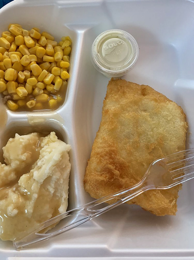 Comfort food perfection: mashed potatoes, corn, and what appears to be fish&mdash;the kind of plate that feels like a warm hug from the inside out.