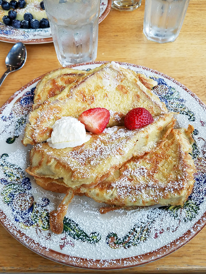 French toast that's achieved the impossible balance: crispy exterior, custardy interior, and enough powdered sugar to make your inner child giggle.