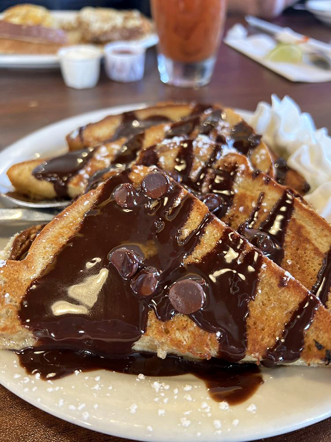 Chocolate-drizzled waffles that make you question why anyone would ever choose a "responsible breakfast" when this masterpiece exists.