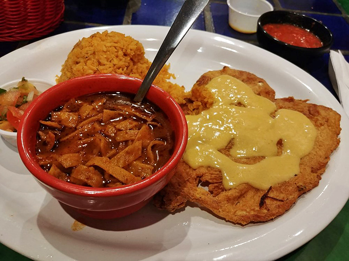 Not your ordinary chicken platter—crispy, golden perfection complemented by tortilla soup so authentic it deserves its own passport.