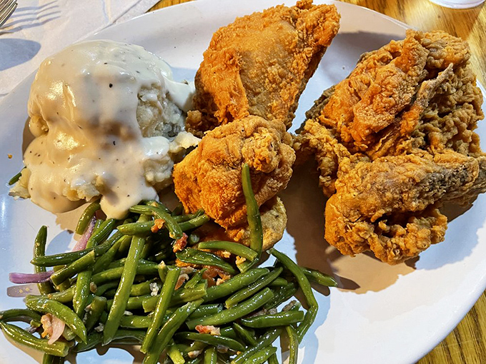 Southern comfort meets Kansas tradition. Golden fried chicken, creamy gravy-topped potatoes, and fresh green beans&mdash;a trio that never disappoints.