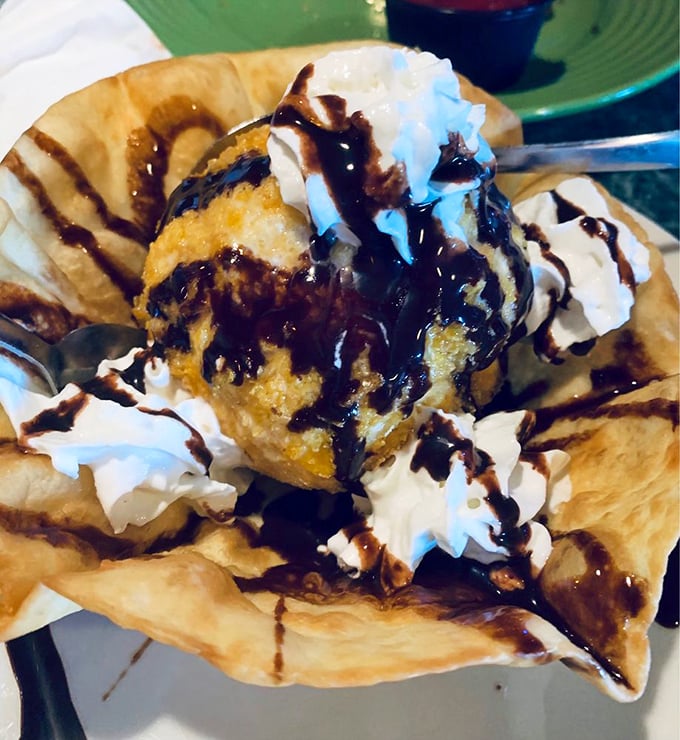 Fried ice cream arrives like a delicious contradiction&mdash;hot, crispy shell giving way to cool, creamy center with chocolate sauce creating flavor fireworks.