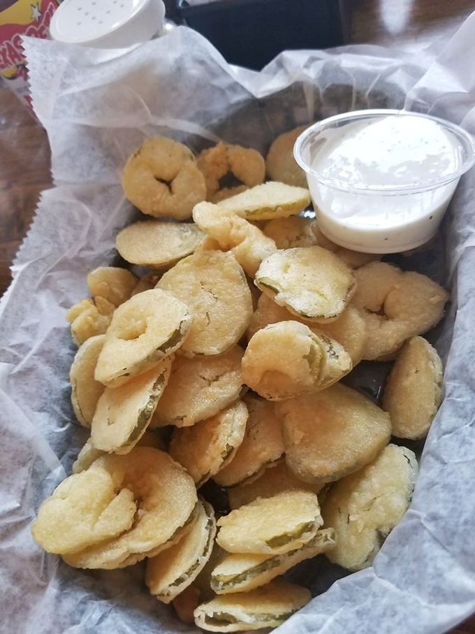 Fried pickles: where tangy meets crunchy in a basket of golden perfection. The ranch dressing is just there to feel included.