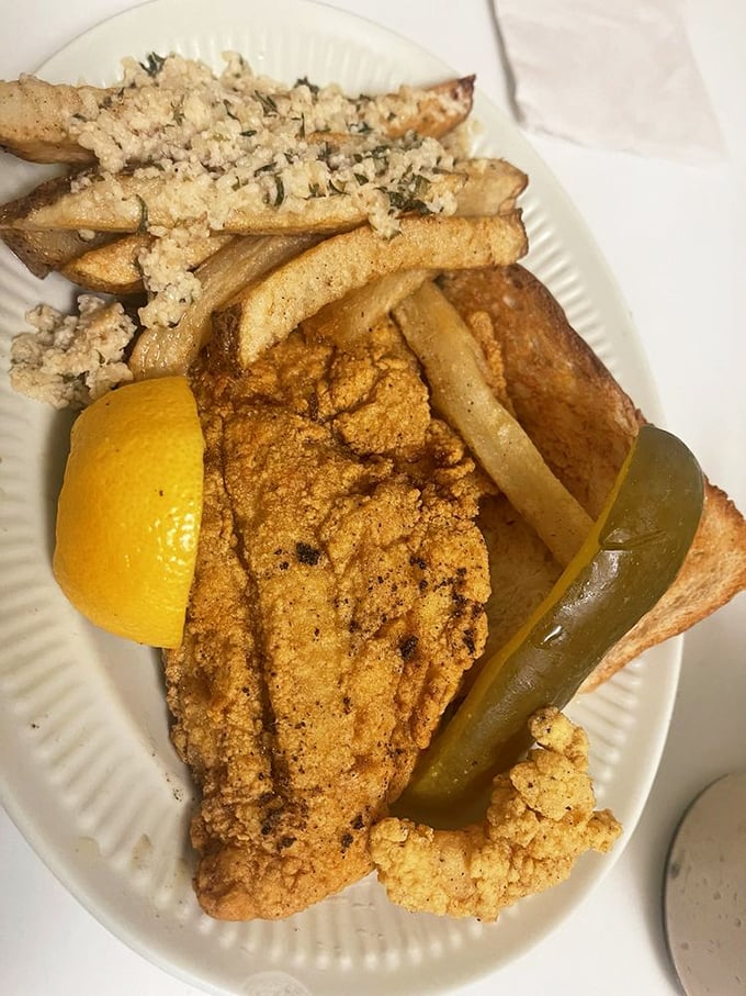 The fried catfish dinner is a study in Southern perfection&mdash;crispy, cornmeal-crusted fish flanked by golden fries and a pickle standing guard.