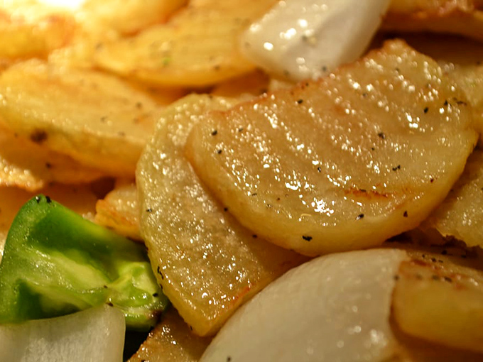 Not your average spuds&mdash;these glistening potato slices have clearly been introduced to flavors that took them far beyond their humble origins.