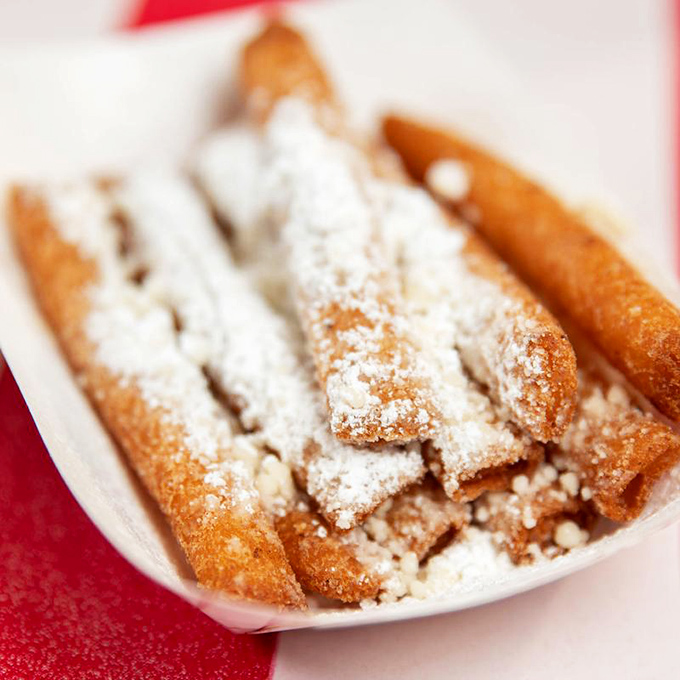 Funnel cake fries: where carnival food meets everyday indulgence. The powdered sugar will inevitably end up on your shirt. Worth it.