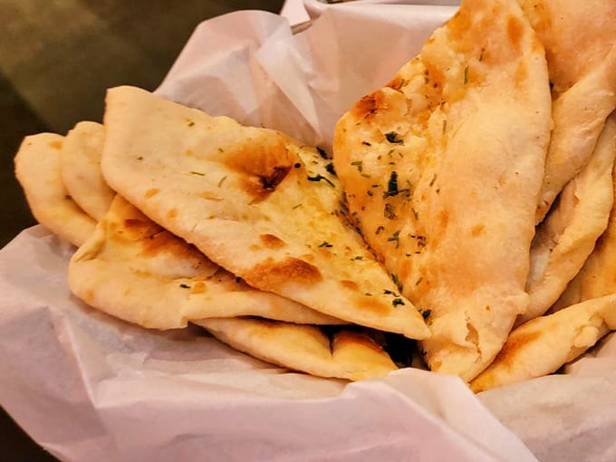 Pillowy garlic naan, fresh from the tandoor's fiery embrace&mdash;the perfect edible utensil for scooping up every last drop of curry.