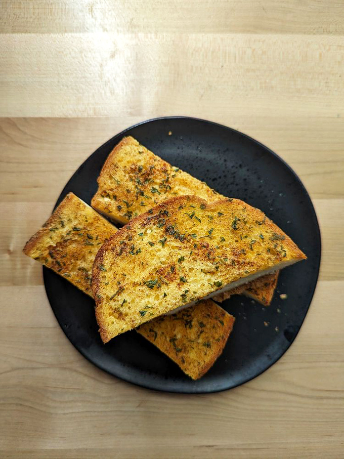 Garlic bread that's achieved the golden trifecta: perfectly toasted, herb-infused, and guaranteed to keep vampires (and first dates) at bay.