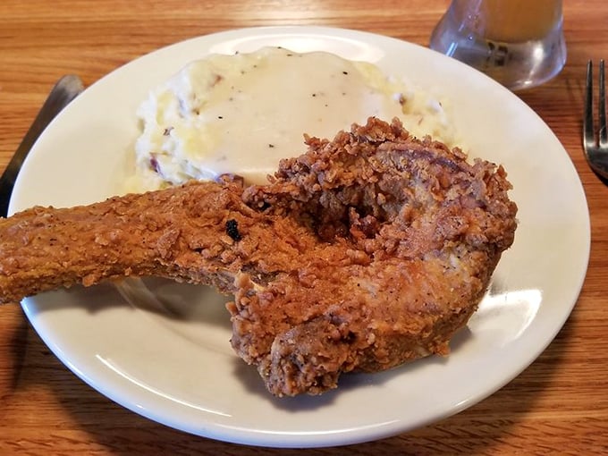 Country fried chicken with a golden crust that shatters just right, nestled beside mashed potatoes that clearly never came from a box.