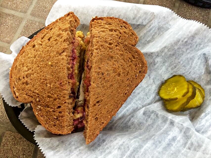 The sandwich sits triumphantly on its paper throne, the bread toasted to that perfect amber hue that signals crispy-yet-tender perfection.