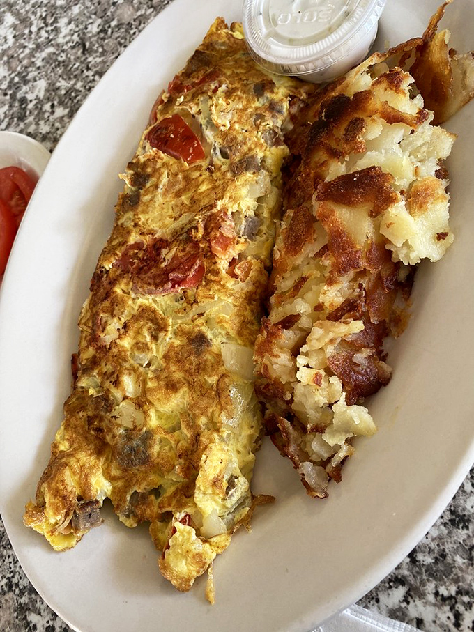 Every great Greek omelet tells a story. This one whispers tales of perfectly seasoned fillings tucked into a golden egg embrace.