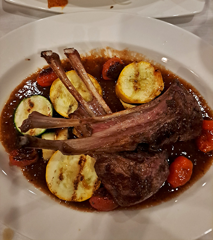 These lamb chops aren't just dinner&mdash;they're edible art, resting in a rich jus with vegetables that actually deserve to share the plate.