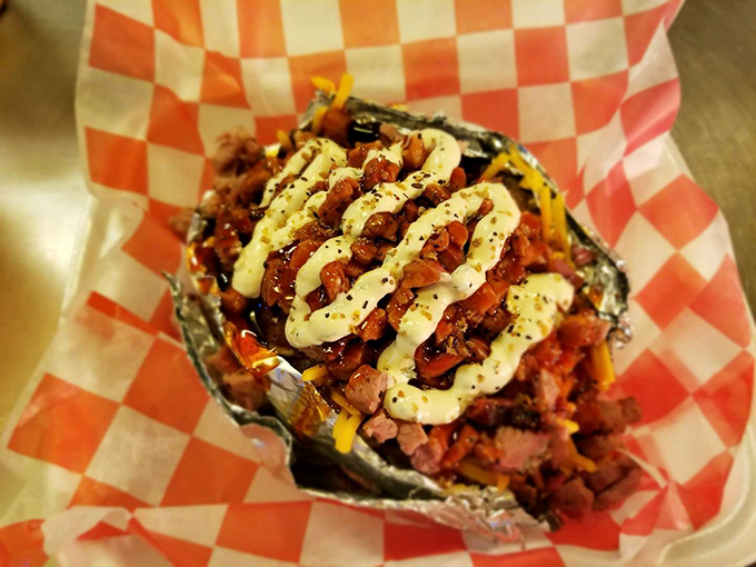A foil-wrapped loaded potato cradles a mountain of toppings&mdash;proof that sometimes the best supporting actors deserve their own standing ovation.