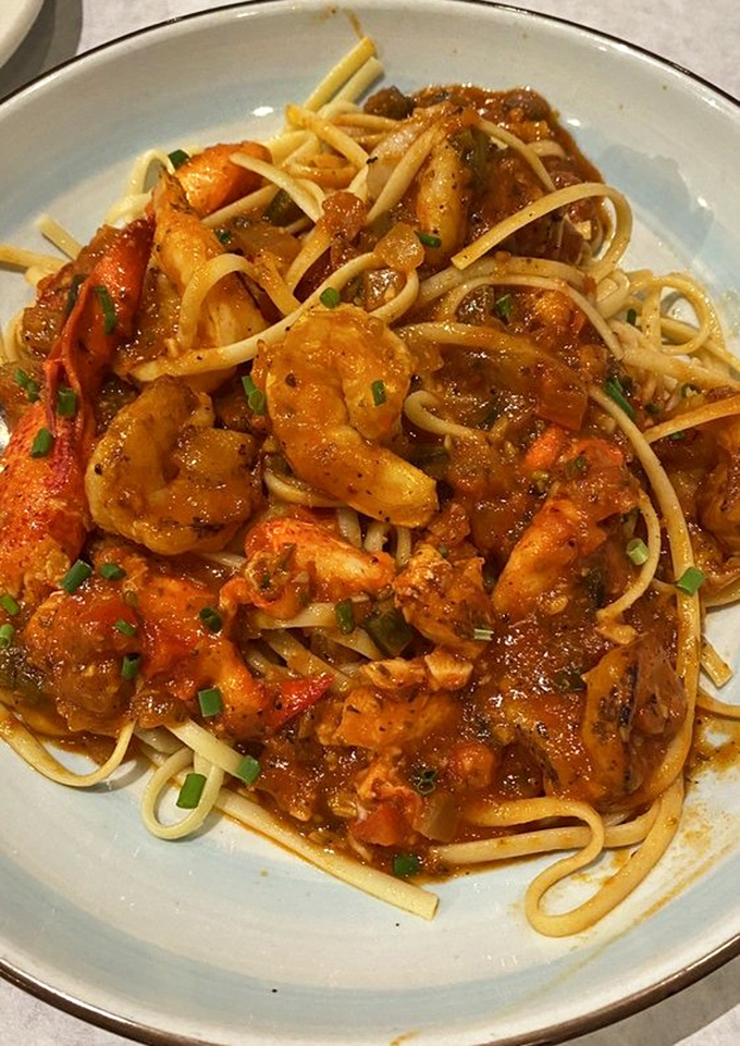 This pasta isn't just dinner; it's a seafood symphony where plump shrimp conduct an orchestra of spices through waves of rich tomato sauce.