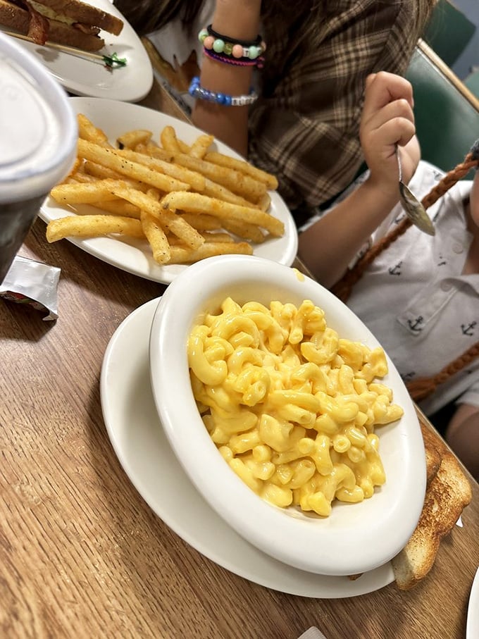 Mac and cheese that glows with that unmistakable yellow promise of comfort, alongside fries that whisper, "Diet? What diet?"