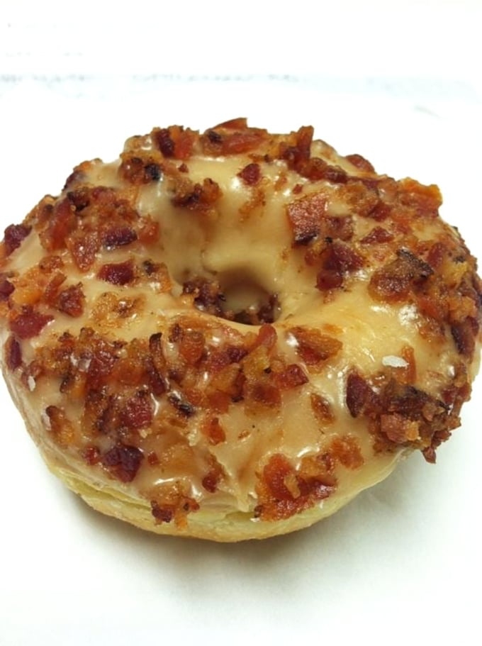 The maple bacon donut &ndash; where breakfast's best friends unite in sweet-savory harmony that feels almost too indulgent for morning consumption.