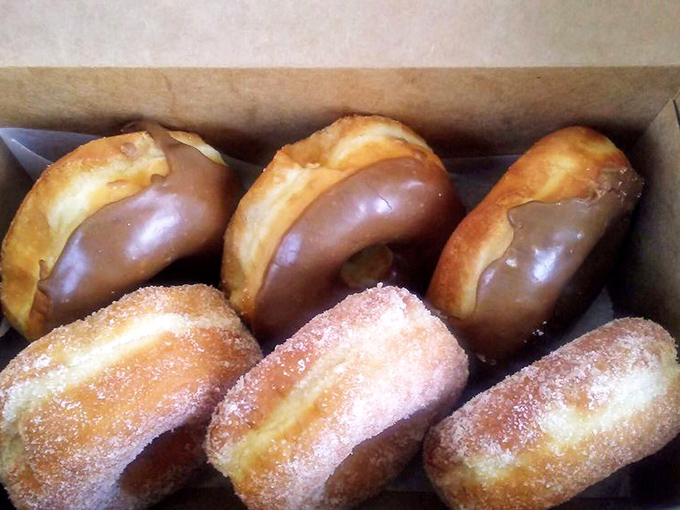 The maple-glazed donuts look like they're auditioning for a breakfast cereal commercial, while their sugar-dusted cousins provide delicious contrast.