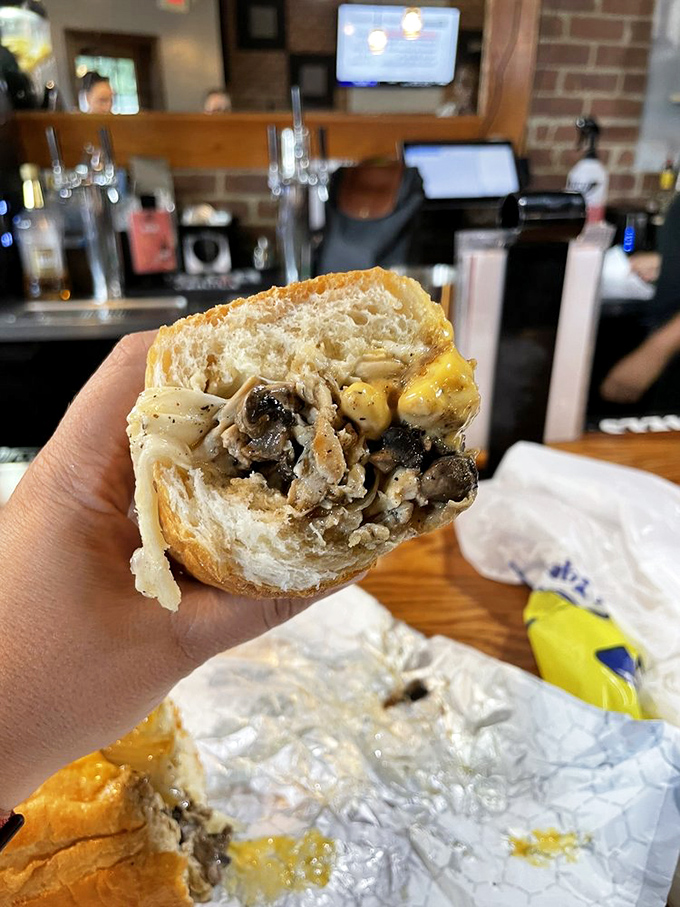 Cross-section perfection reveals the inner workings of sandwich engineering. Like a delicious geology lesson where every layer tells a story of flavor.