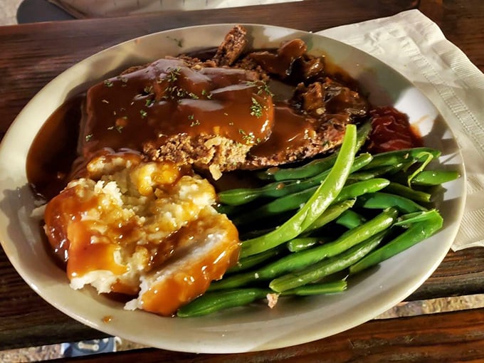 A plate that grandma would approve of – meatloaf swimming in gravy, mashed potatoes standing by, and green beans for that token vegetable appearance.