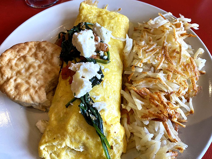 This Mediterranean omelet brings vacation vibes to your breakfast table. Spinach, feta, and what appears to be a biscuit sidekick &ndash; the breakfast equivalent of a perfect Mediterranean holiday.