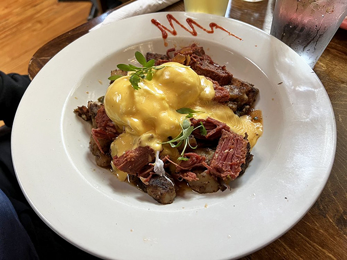Corned beef hash that makes deli owners weep with envy. That golden hollandaise crown turns this humble breakfast classic into morning royalty fit for champions.