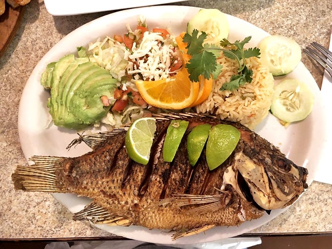 This whole fried fish stares back at you as if to say, "Yes, I'm delicious. The lime wedges are just my accessories."