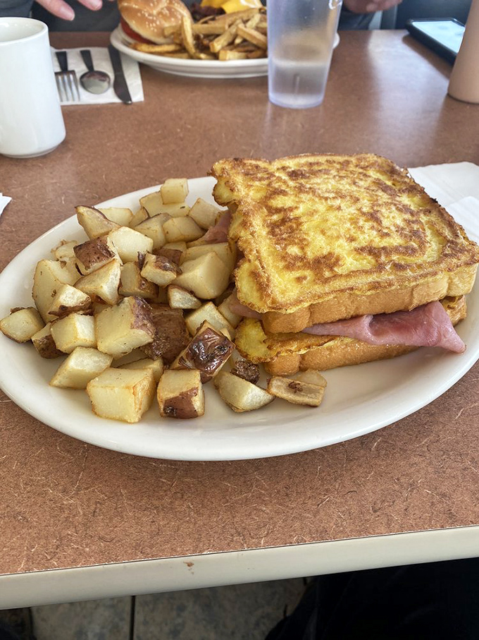 The Monte Cristo sandwich—that beautiful marriage of breakfast and lunch where French toast decided to get serious about ham and cheese.