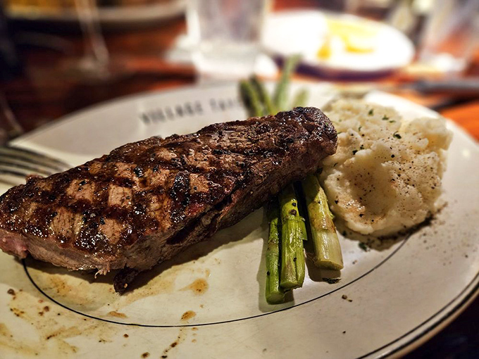 A masterclass in simplicity: perfectly grilled New York Strip, asparagus standing at attention, and a potato that clearly went to finishing school.