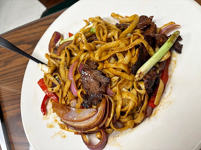 This beef and noodle stir-fry isn't just a dish &ndash; it's a symphony of textures where each bite conducts a different section of the flavor orchestra.