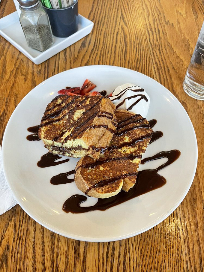 French toast that's had a romantic encounter with Nutella and chocolate sauce. Breakfast or dessert? The delicious answer is: absolutely both.