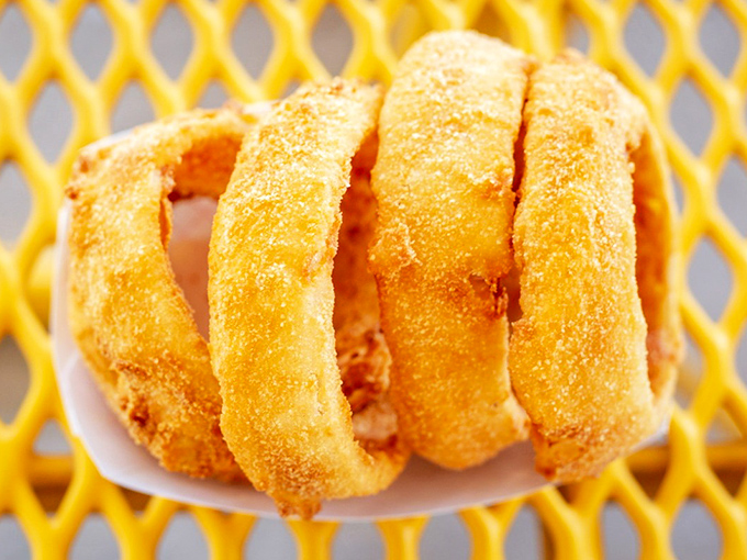 These aren't just onion rings&mdash;they're golden halos of happiness, fried to that perfect crunch that echoes across the parking lot.