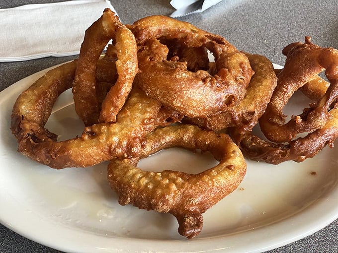 Onion rings that shatter with satisfying crispness, revealing sweet onion beneath. These golden halos aren't just sides&mdash;they're the supporting actors that steal the show.