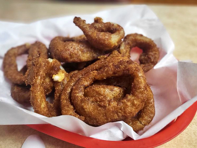 A burger in its natural habitat &ndash; wrapped in paper, ready to be devoured, with house-made chips standing guard nearby.