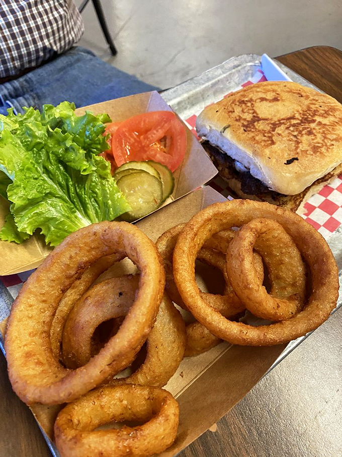 Crispy golden onion rings that shatter with each bite, served alongside fresh veggies that pretend you're making healthy choices.