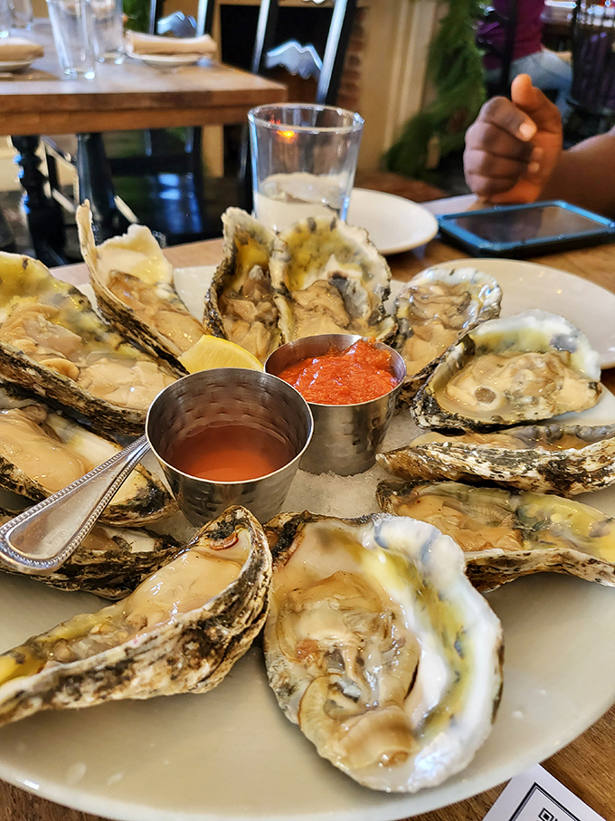 A platter of oysters arranged like a delicious clock face, with dipping sauces standing in as the hands pointing to "time to eat."