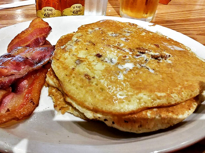 Pancakes so fluffy they could float away if not anchored by that perfectly crisp bacon. Breakfast doesn't get more American than this.